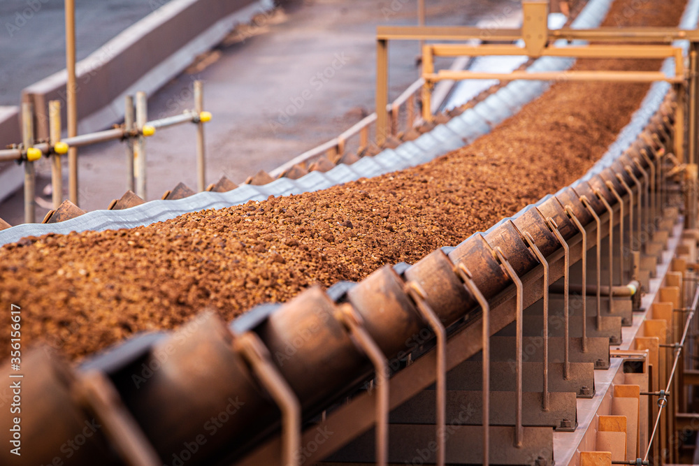 Conveyor belt moving iron ore Stock Photo | Adobe Stock