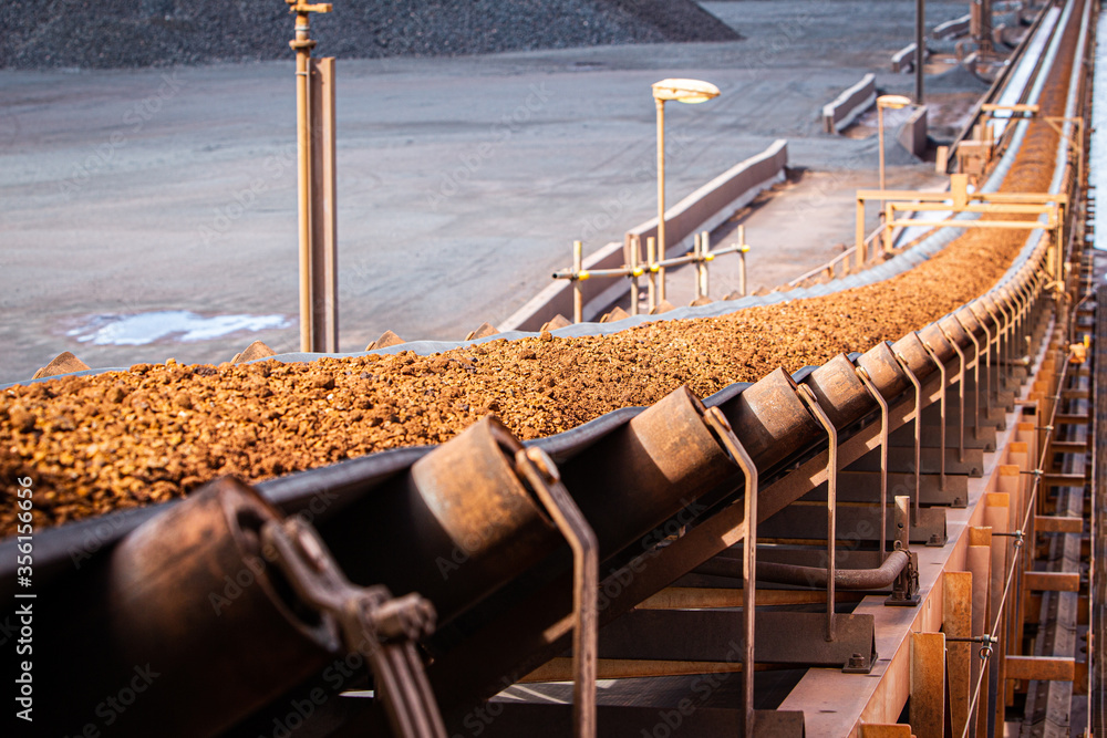 Conveyor belt moving iron ore Stock Photo | Adobe Stock