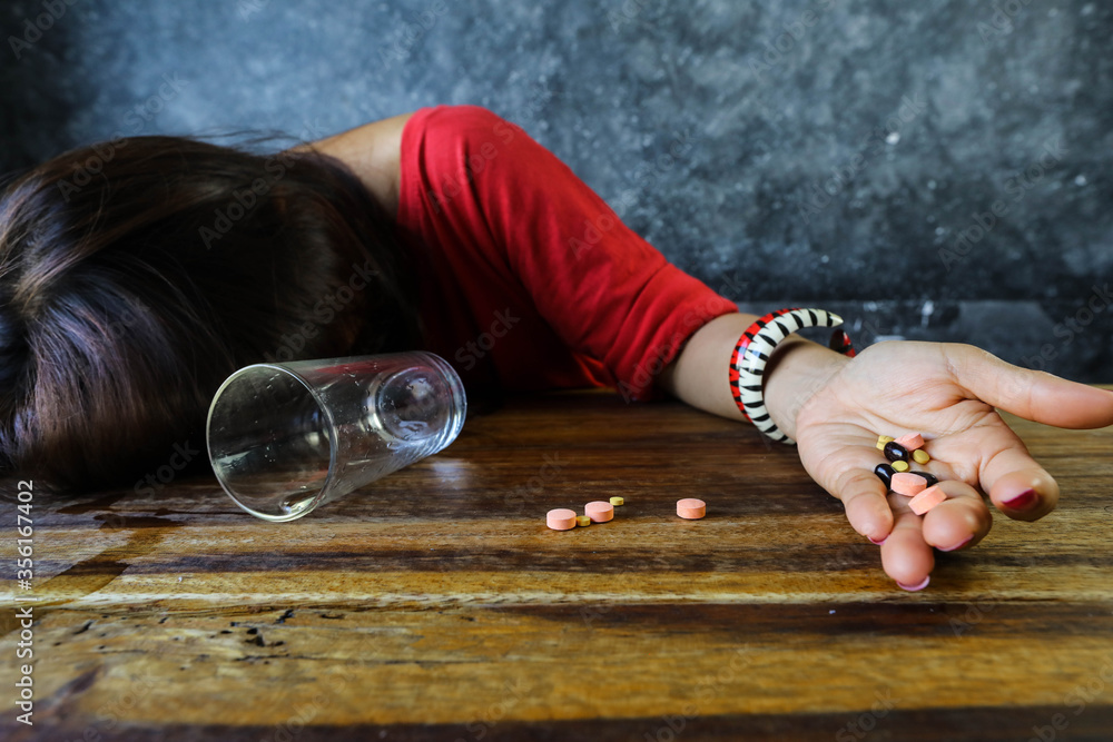 Photo & Art Print Woman taking medicine overdose and lying on the ...