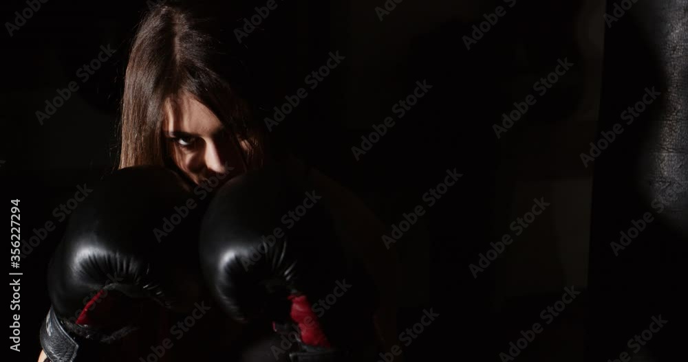 Female boxer training in the dark ring. Slow motion. Silhouette. Boxing ...