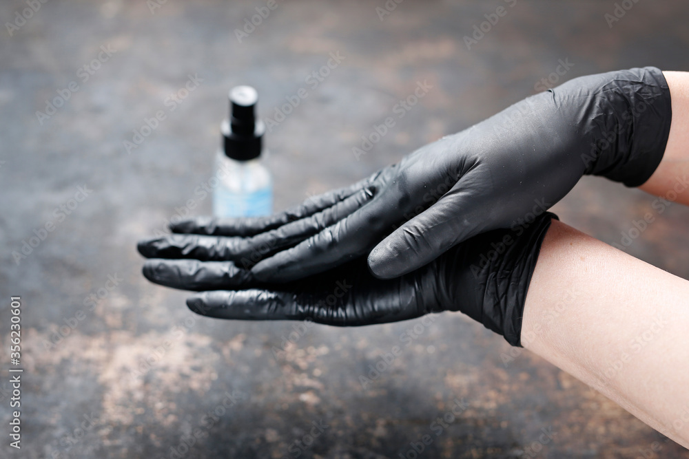 Washing hands with a disinfectant liquid. The woman shows the stages of ...