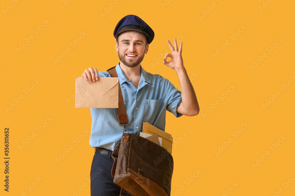 Handsome young postman on color background Stock Photo | Adobe Stock