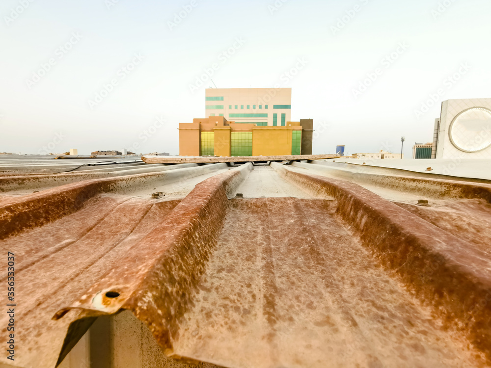 old and rusty slums roof top and city buildings in the background Stock ...