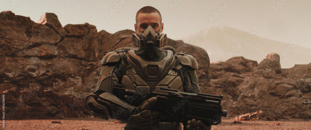 Caucasian male star trooper posing with a gun on a hostile planet ...