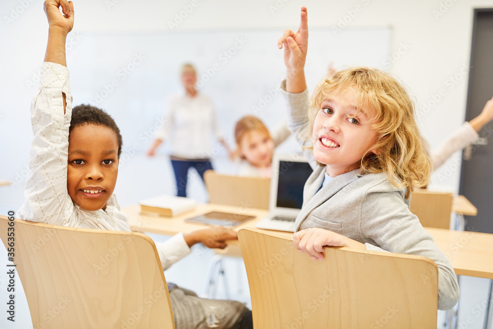 Zwei Schüler melden sich im Unterricht Stock Photo | Adobe Stock