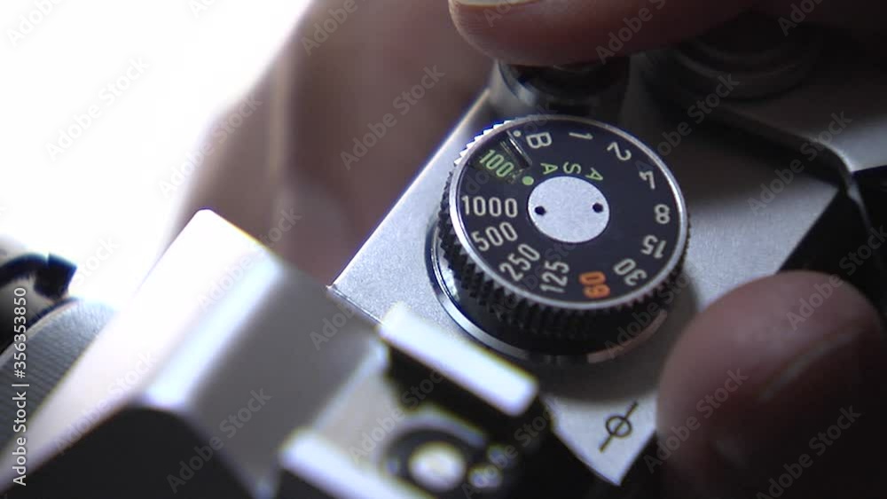 Guy is changing the shutter speed setting on old and vintage looking ...