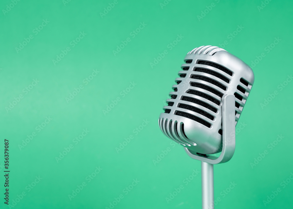 Retro microphone with copy space on green background Stock Photo ...