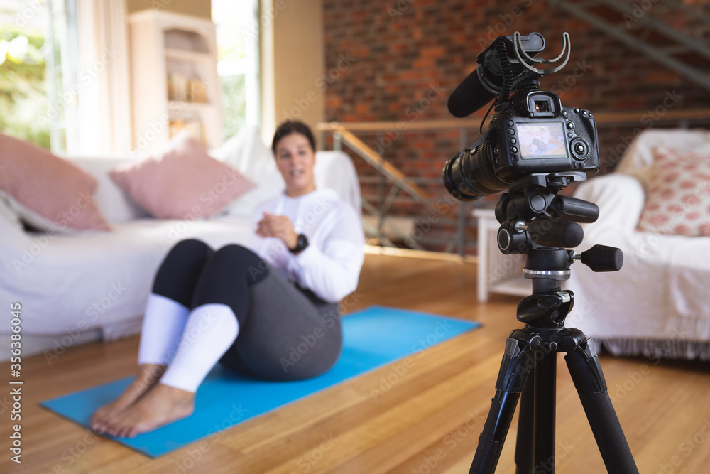 Plus size female vlogger self isolating exercising at home Stock Photo ...