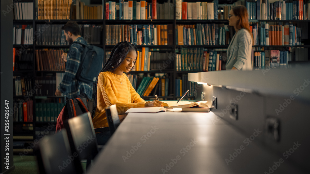 University Library: Gifted Black Girl uses Laptop, Writes Notes for the ...