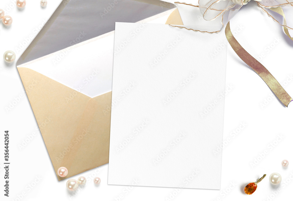 Blank invitation card on craft envelope and wedding decoration ...