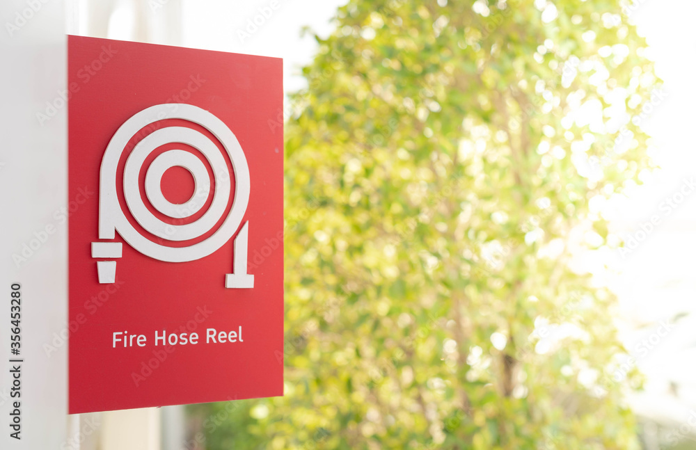 Red fire alarm sign on the white wall for safety first and sign for ...