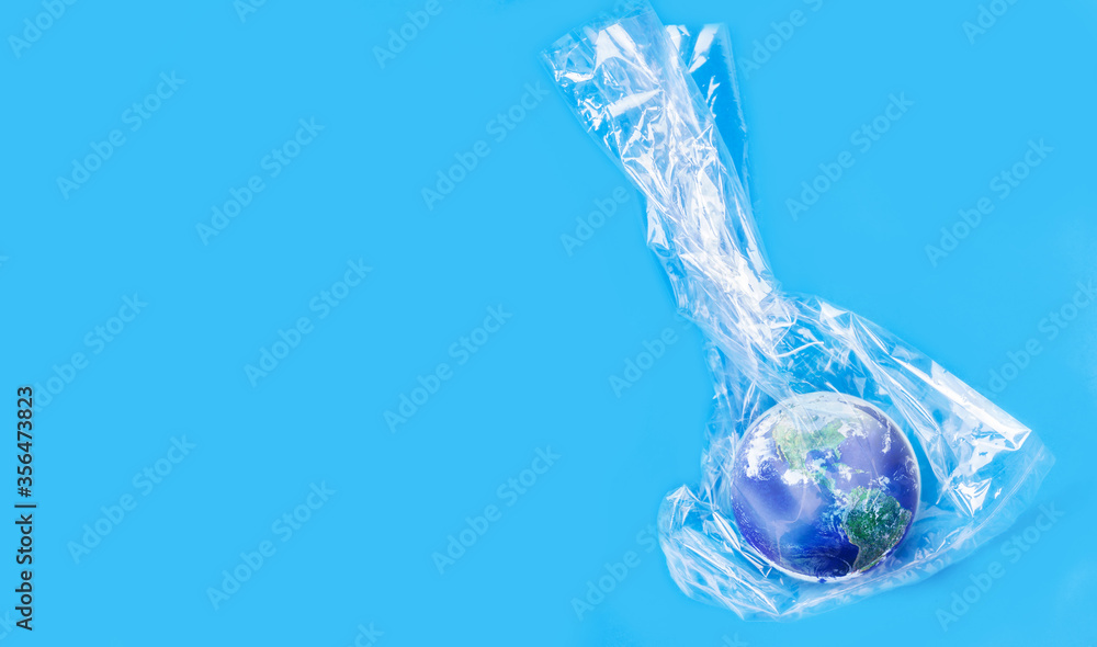 Planet earth in a plastic bag on light blue background, Pollution from ...