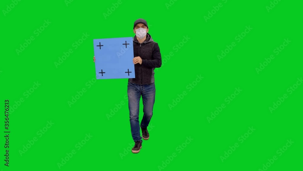Vidéo Stock Man in casual wear and protective mask walking with blank ...