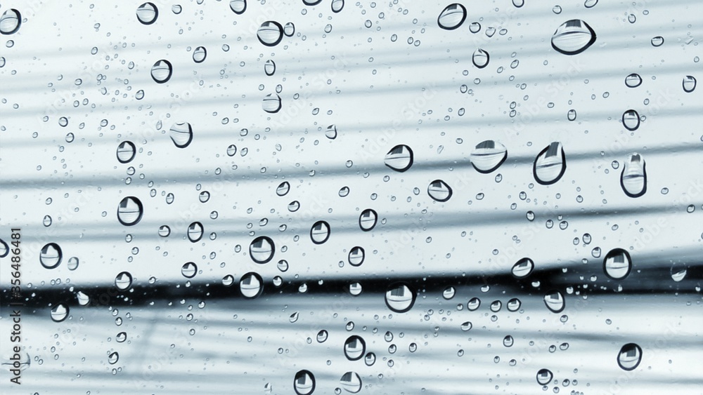 Blurred rain drops on car window with heavy rainy and dramatic weather ...