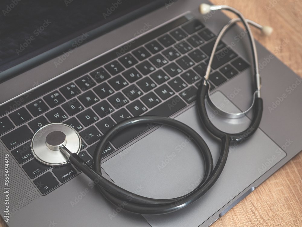 Stethoscope keyboard laptop computer isolated on blue background ...
