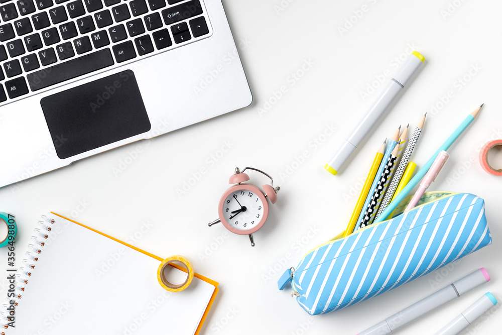Flat lay top view laptop, pencil case and stationery on white table ...