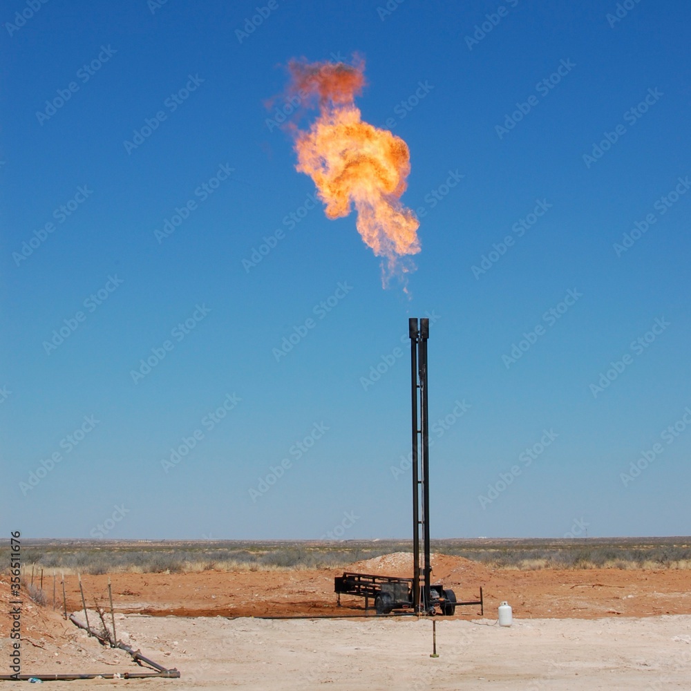 Small gas flare at a well in the west Texas oilfield Stock Photo ...
