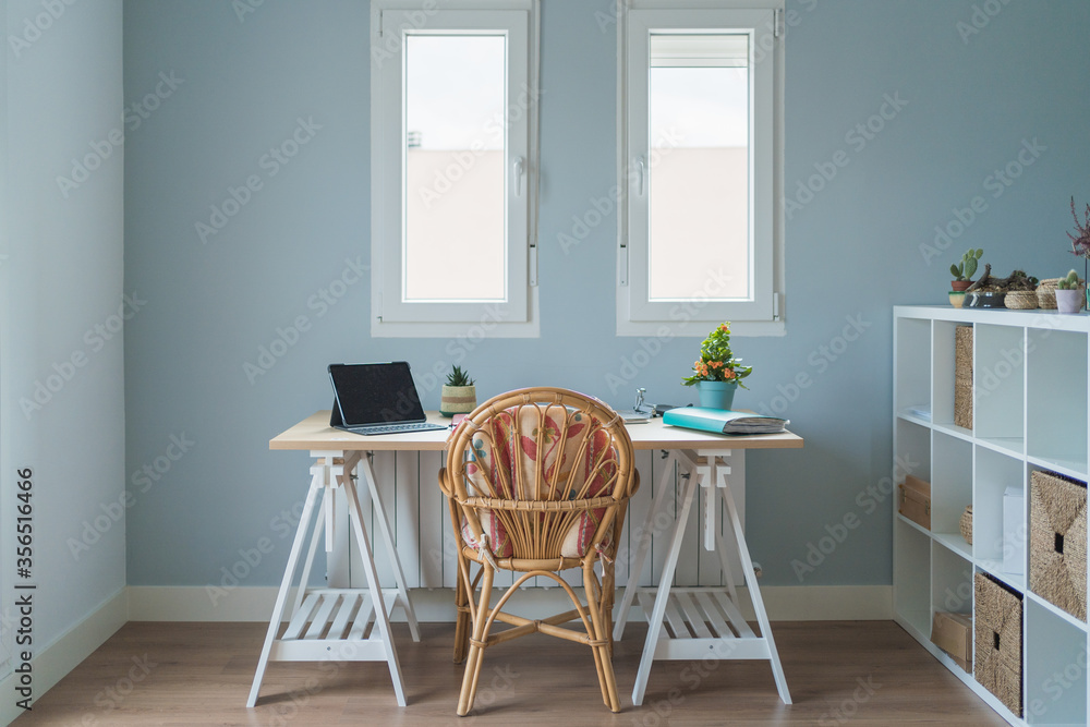 Interior of modern room and workplace with wooden desk with laptop and ...