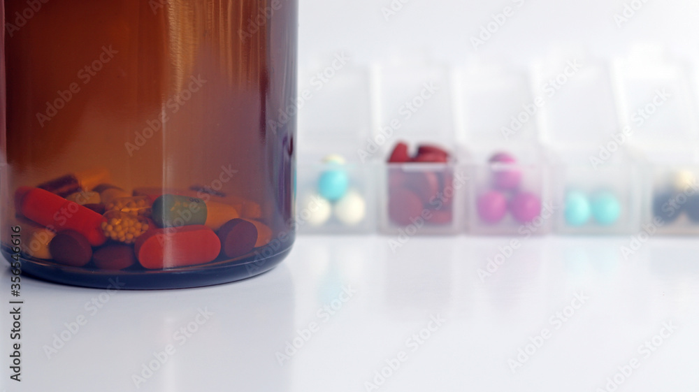 Ferrous Fumarate in pill box with tablets, capsules, vitamins in brown ...