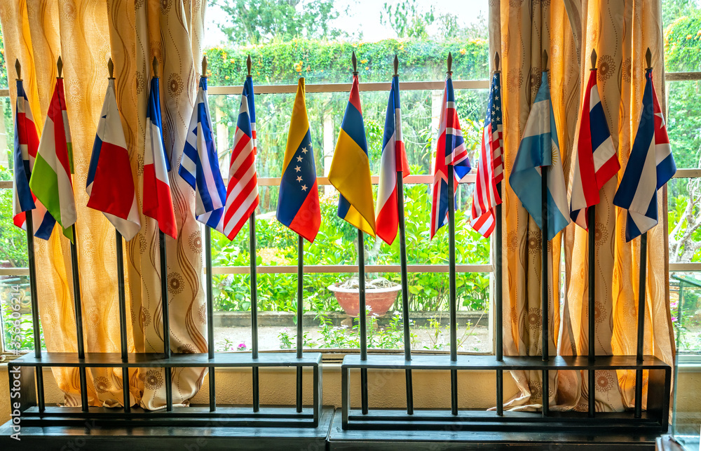 Group of flags of many different nations trong phòng infront of a ...