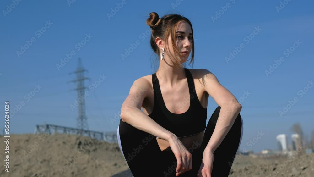 Fashion woman take off mask face close up sitting industrial piping ...