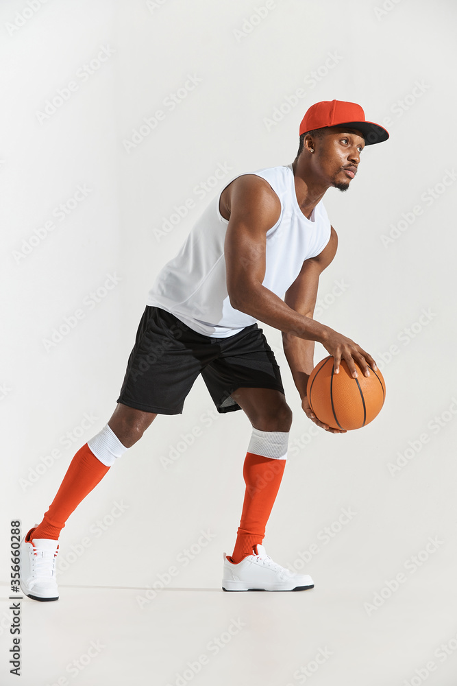 full length photo of a dark-skinned athletic basketball player in ...
