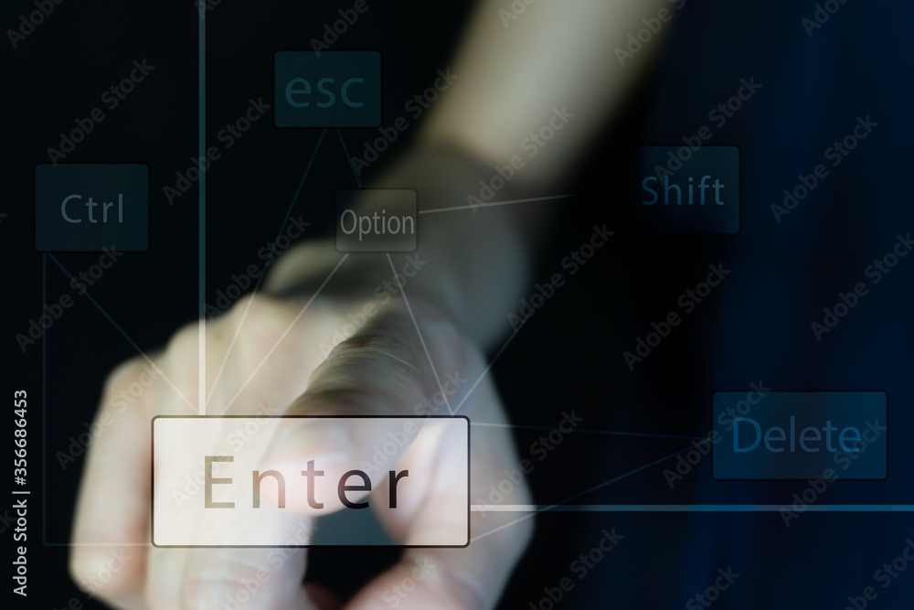 A business person finger point at the transparent enter keyboard on the ...