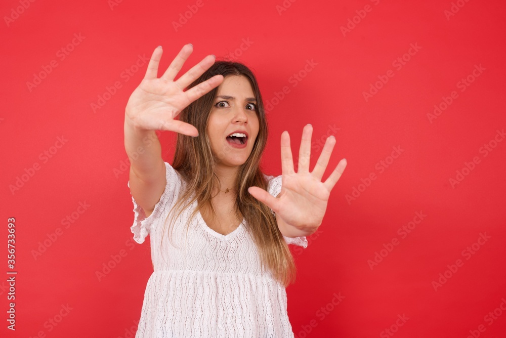 Dissatisfied female model frowns face, has disgusting expression, shows ...