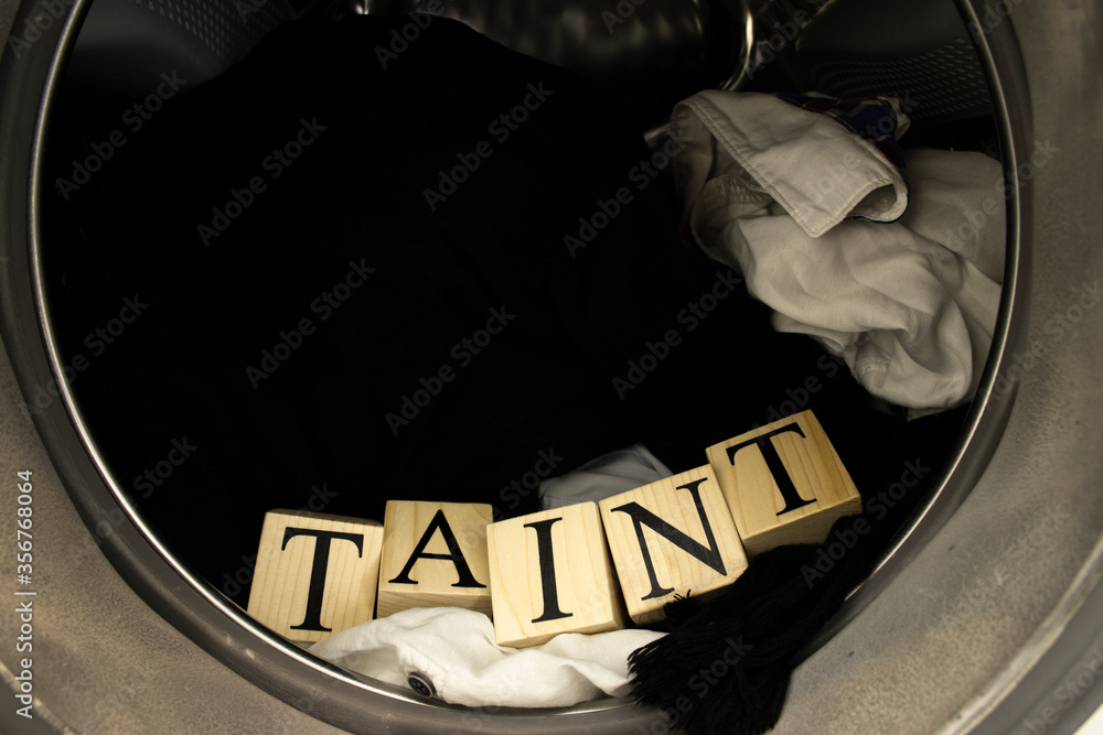 Inside the washing machine. Inside, there is laundry and text from ...