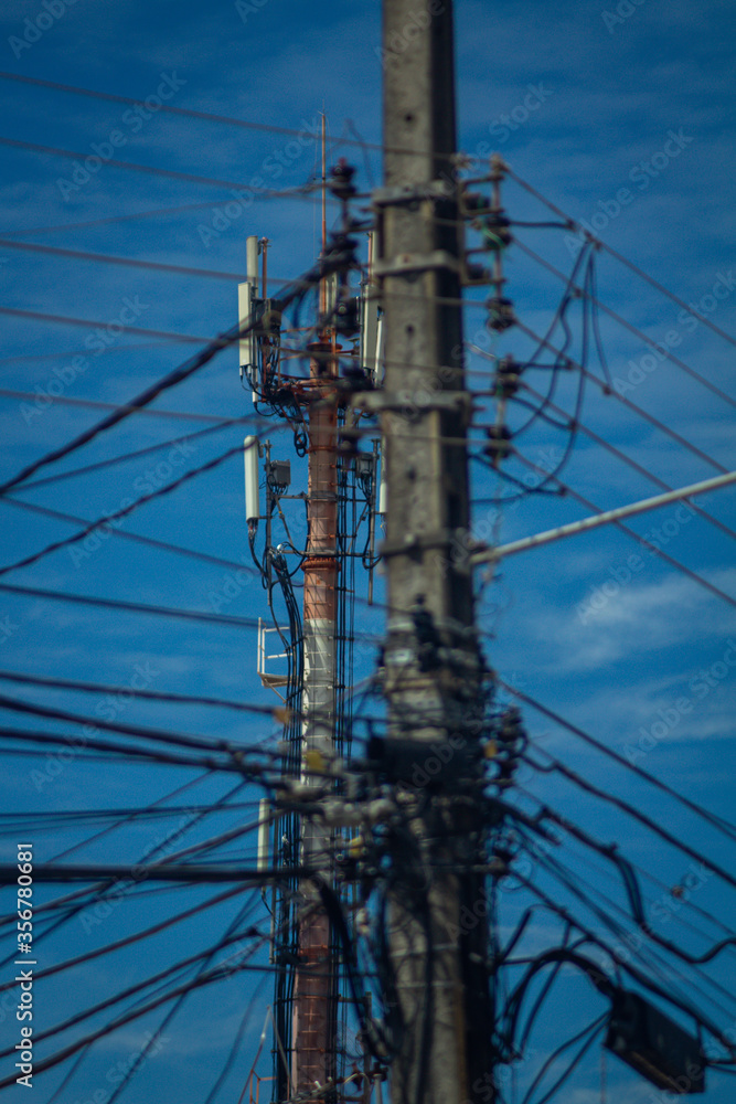 Countless cables on one pole. Visual pollution in large cities by ...