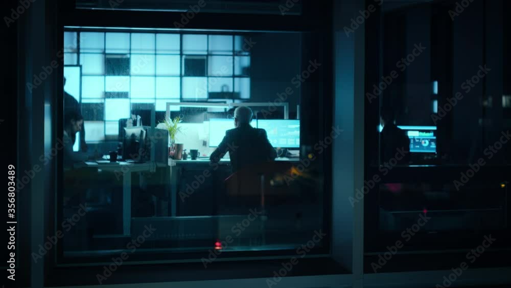 Footage from Outside the Window: Senior Businessman Sitting in Front of ...