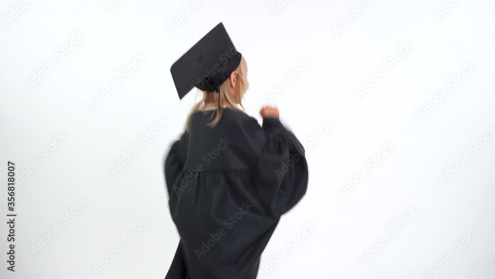Portrait Happy little graduate celebrating with her graduation cap and ...