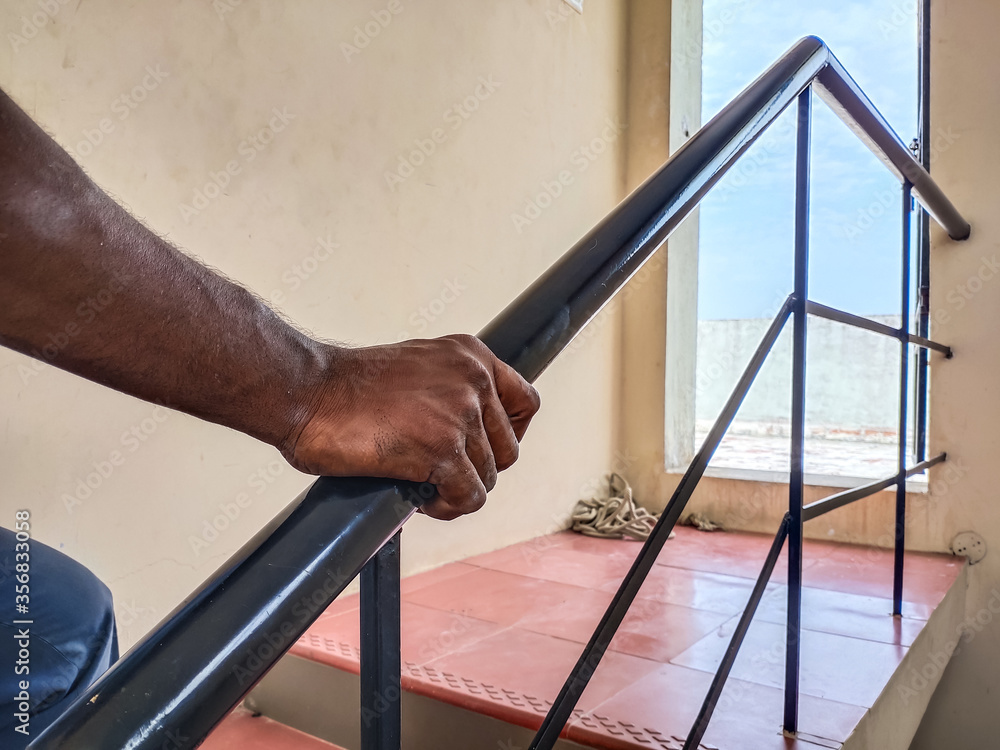 Man hand holding and using handrail. Person using handrail near ...