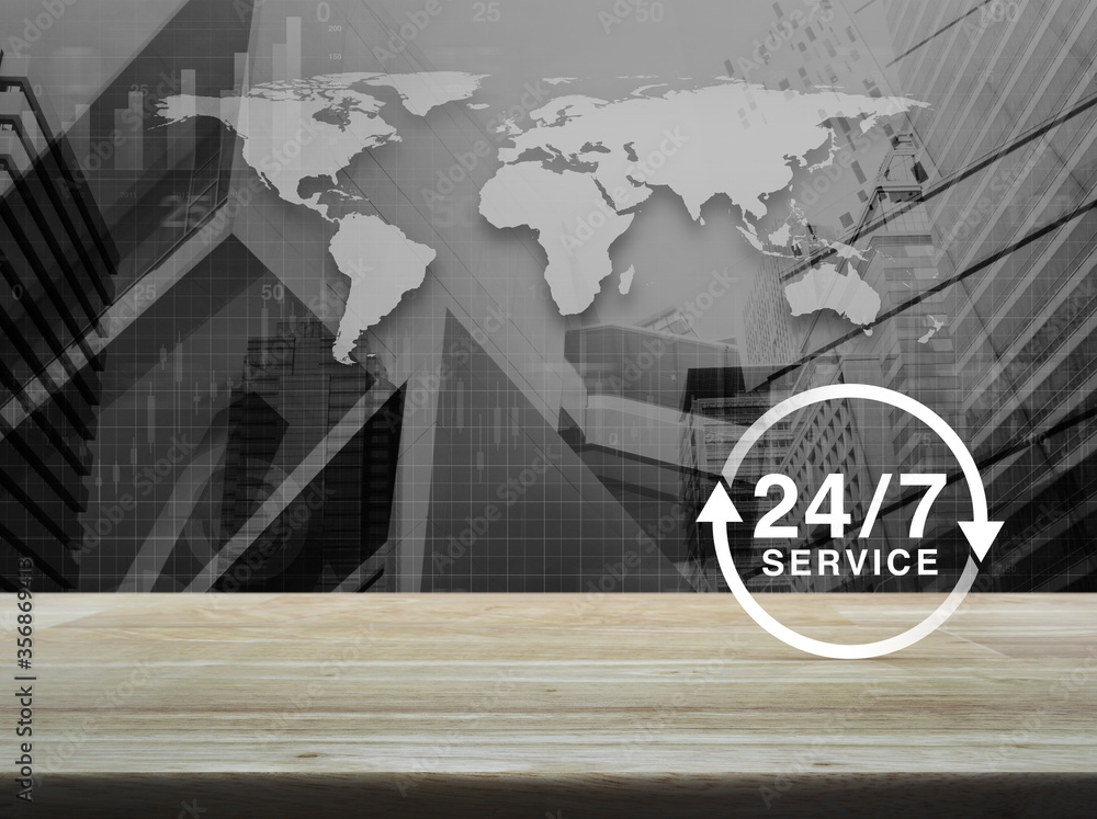 24 hours service icon on wooden table over black and white world map ...
