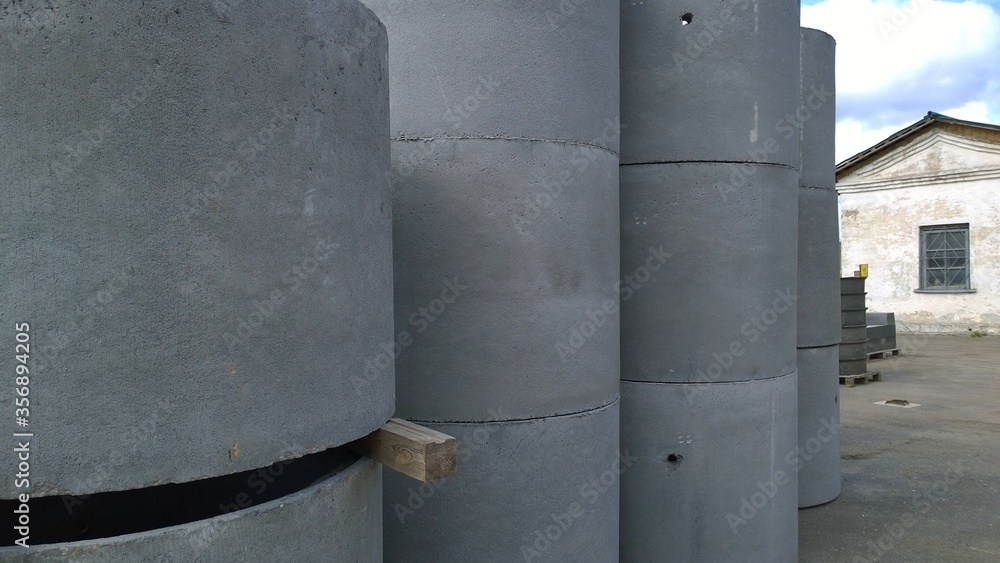 Row of Reinforced concrete products. Well rings. Water supply ...