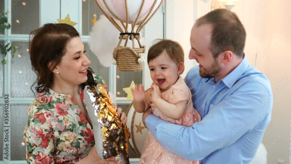 Young happy family playing with a baby in the living-room Stock Video ...