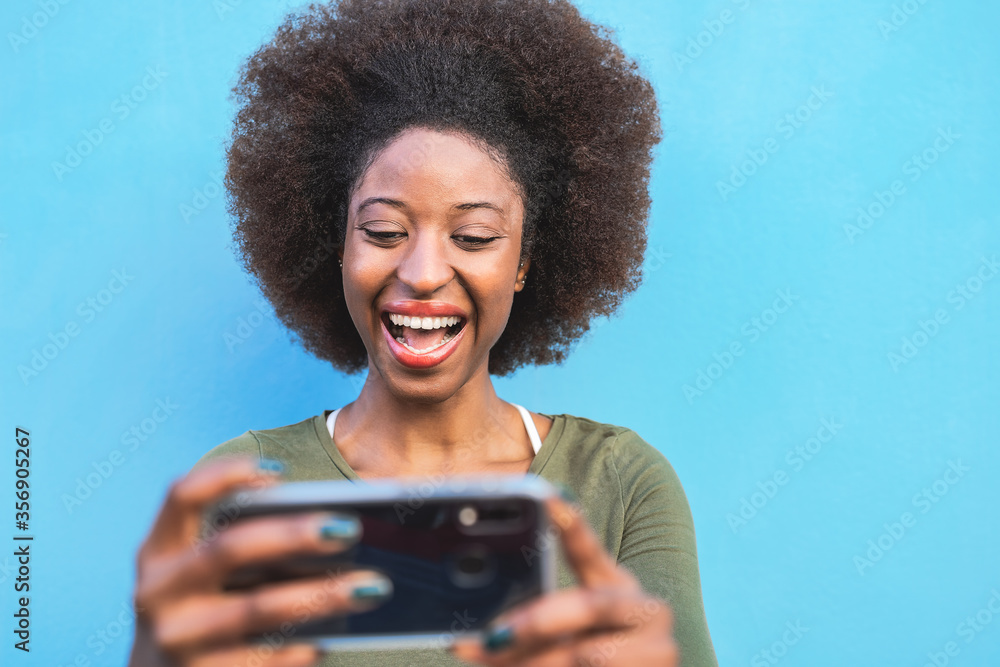 Young Afro woman using mobile smartphone - Happy African girl having ...