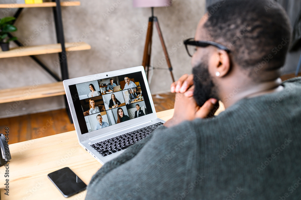 Virtual meeting with many people together. African-American young guy ...