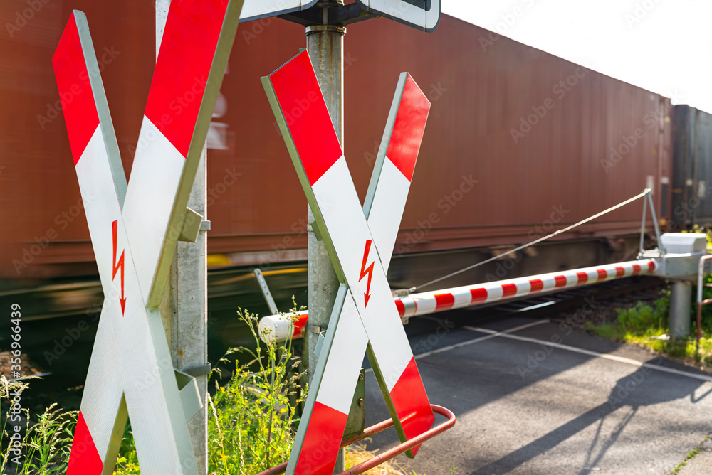 Closed barrier at the railway crossing with St. Andrew cross, visible ...