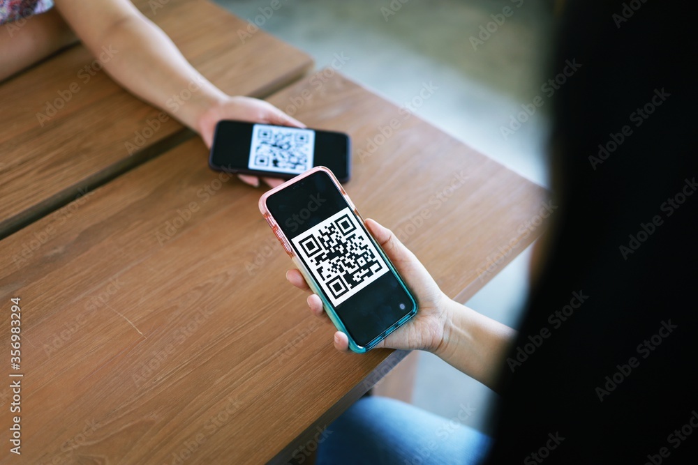 Qr code payment. Woman scanning QR code online shopping cashless ...