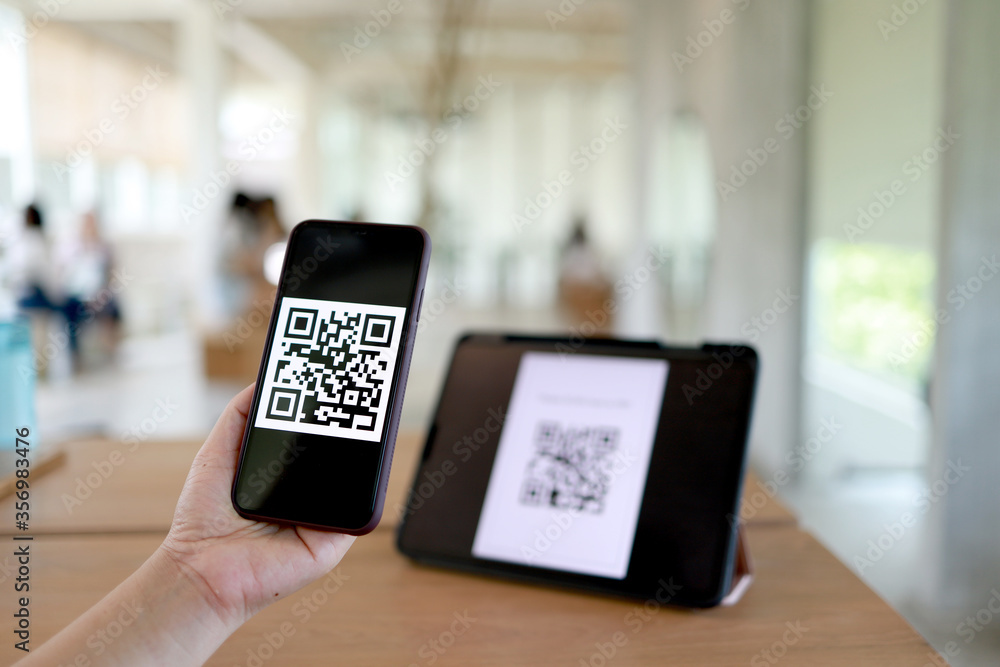 Qr code payment. Woman scanning QR code online shopping cashless ...
