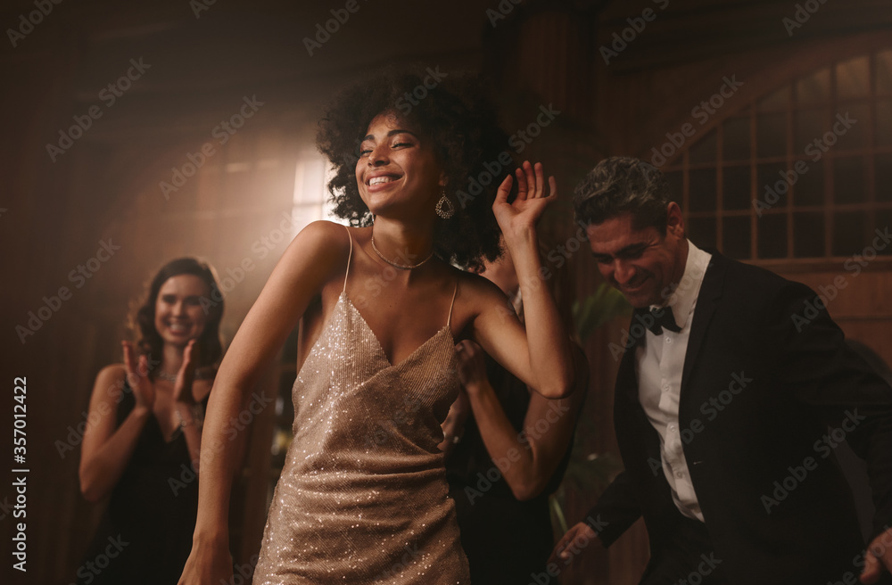 Foto de Attractive young woman dancing at a nightclub do Stock | Adobe ...