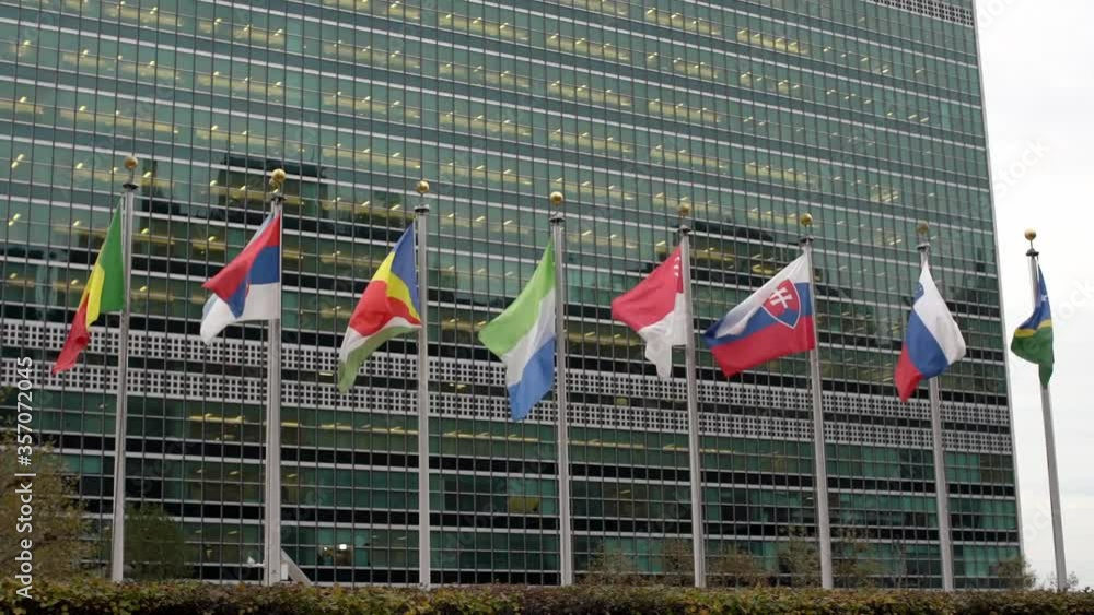 Multiple flags in front of the United Nations headquarters in New York ...