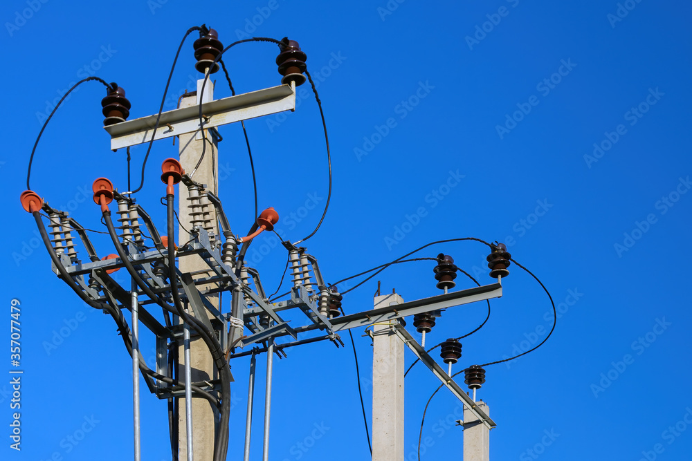 High voltage concrete and steel electrical power post top close up with ...