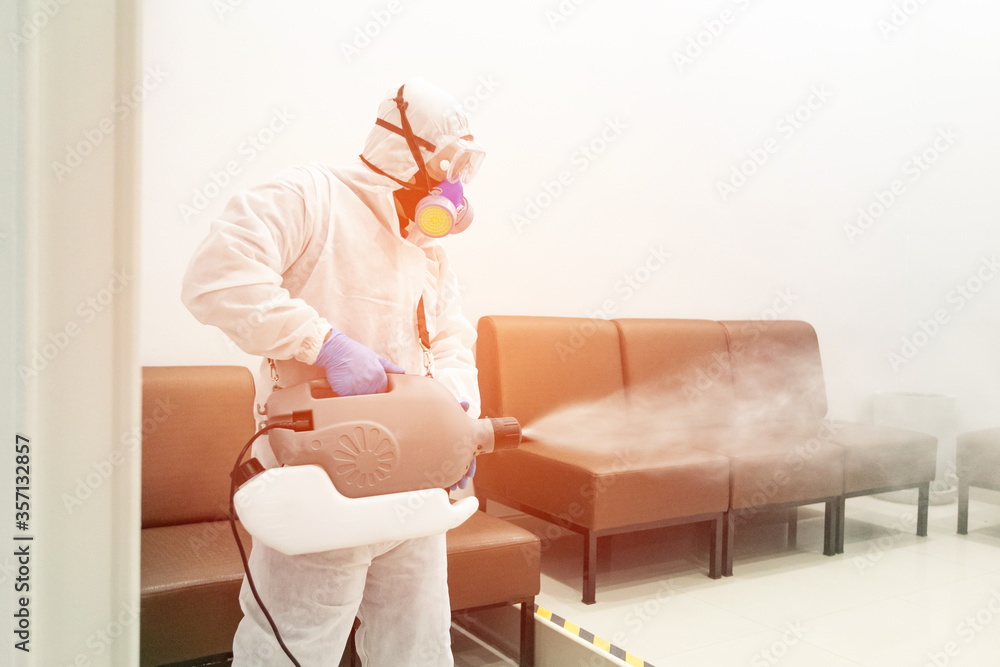 Worker wearing (ppe) protective equipment suit, gloves, mask, and mask ...