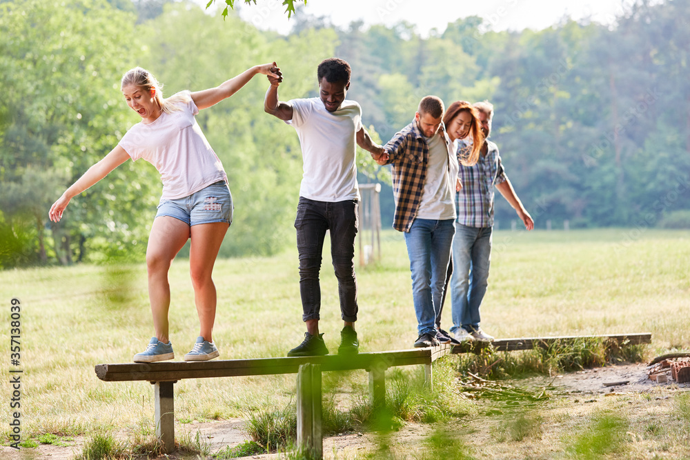 Team balancing on trim you course Stock Photo | Adobe Stock