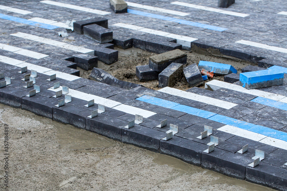 Construction work on pavement. Installation of concrete paver blocks on ...
