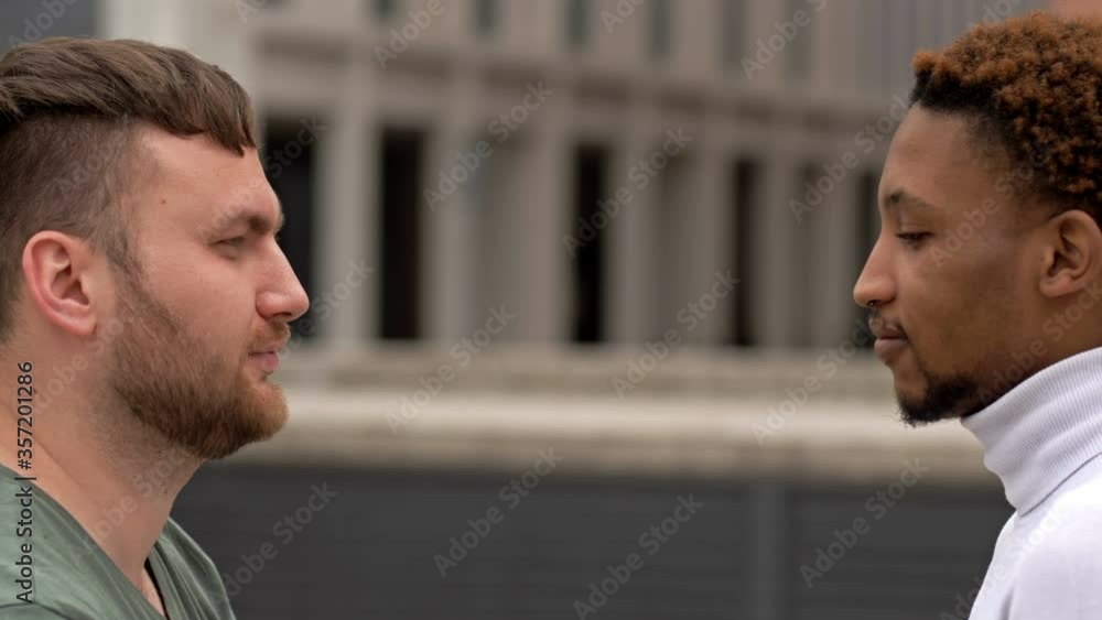 The black guy and the white man are staring at each other. Concept of ...