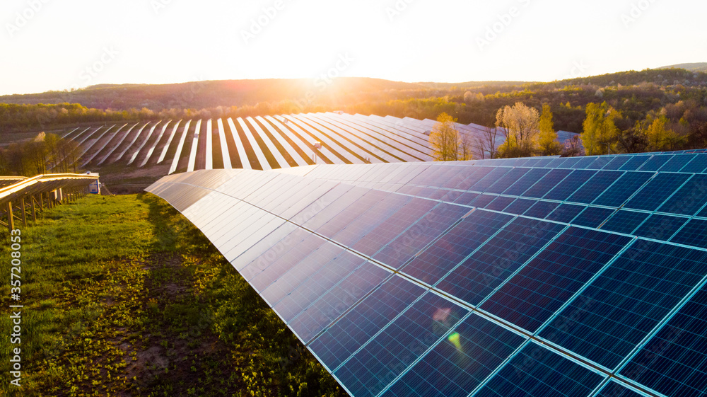 Solar panels (solar cell) in solar farm with sun lighting to create the ...