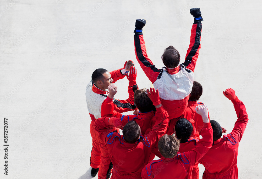 Racer and team cheering on track Stock Photo | Adobe Stock